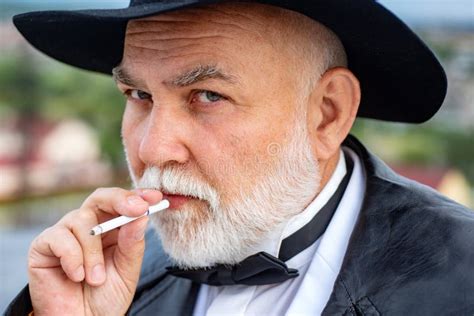 Closeup Face Of Serious Stylish Hipster Grandfather In Leather Coat