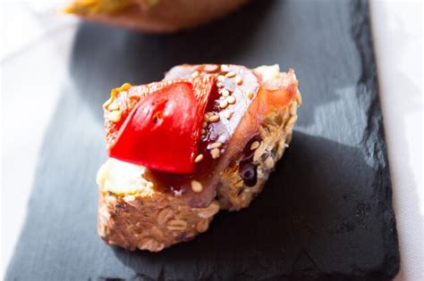 Premium Photo Ham And Pepper Tapa A Small Slice Of Bread On Which A Small Portion Of Food Is