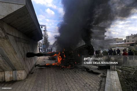 Syrian Kurds Stand Next To The Destroyed Statue Of Basel Al Assad