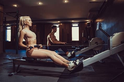 Premium Photo Athletic Sexy Woman Doing Exercise Using Machine In Gym