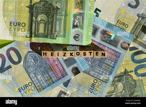 The German Word For Heating Costs With Wodden Cubes And Euro Bills