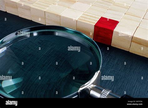 Wooden Cubes And One Red Next To A Magnifying Glass Talent Acquisition