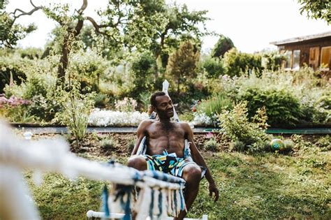 Premium Photo Shirtless Man Relaxing On Hammock In Yard
