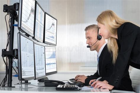 Business People Analyzing Data Displayed On Computer Screens Stock