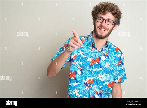 Happy Young Bearded Tourist Man Pointing Finger And Directing Stock