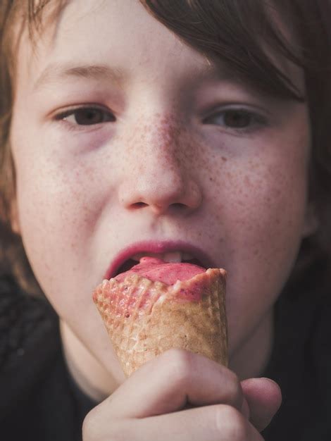 Premium Photo Close Up Of Boy Licking Ice Cream