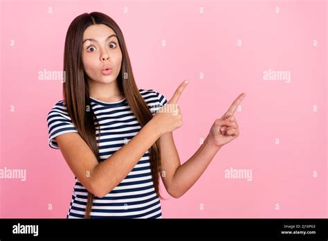 Photo Of Shiny Impressed Girl Wear Striped Outfit Pointing Empty Space