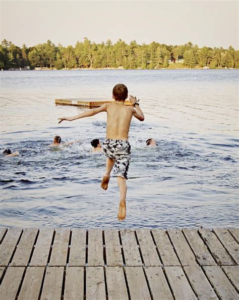 Boy Jumping Into Lake A Year Boy Jumps Off A Dock Into Lake At Summer Camp AFF Year