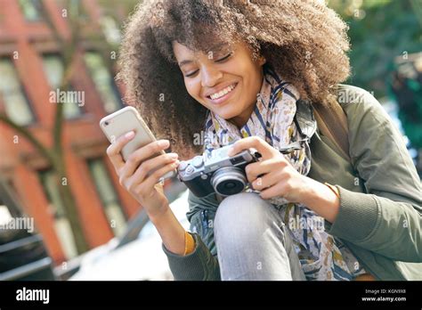 Woman Photographer Transfering Files From Camera To Smartphone Stock Photo Alamy