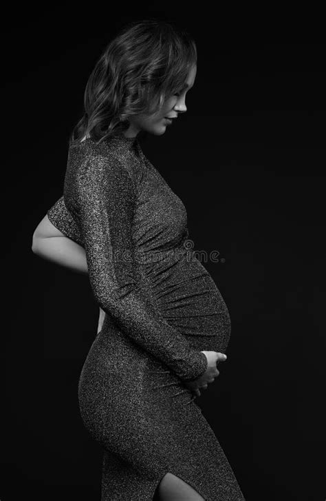 Black And White Portrait Of Pregnant Female In Sequin Dress With Hands