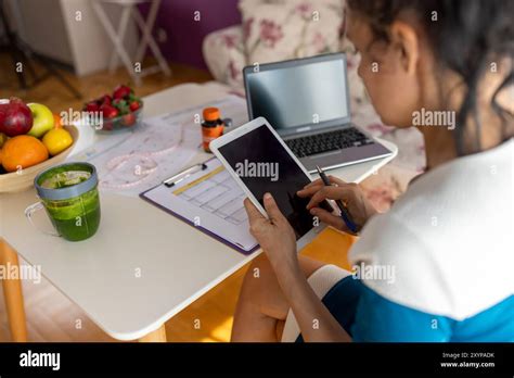 Nutritionist Dietitian Woman Writing A Diet Plan With Healthy Fruits