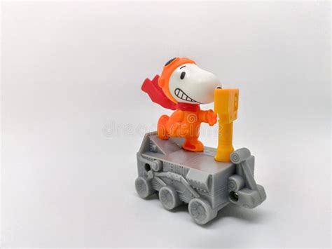 Toy Figure Of Snoopy In Astronaut Suit On Lunar Rover With White