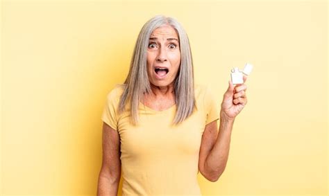 Premium Photo Middle Age Pretty Woman Looking Very Shocked Or