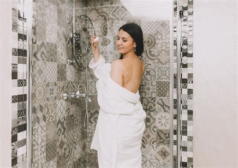 Premium Photo A Woman Takes A Shower Enjoying The Splashes Of Water