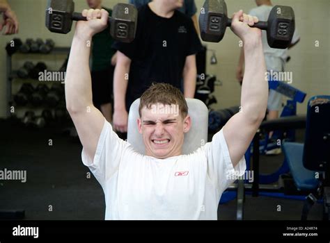 Students Work Out In A Weight Training Room In A High School Class