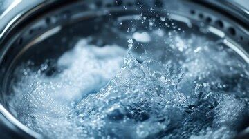 Water Splashing In A Washing Machine During The Wash Cycle With Bubbles