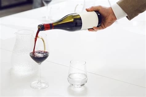 Premium Photo Expert Sommelier Pouring Red Wine To Glass Close Up