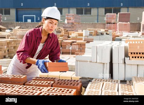 Asian Female Calculating Bricks Before Selling Stock Photo Alamy