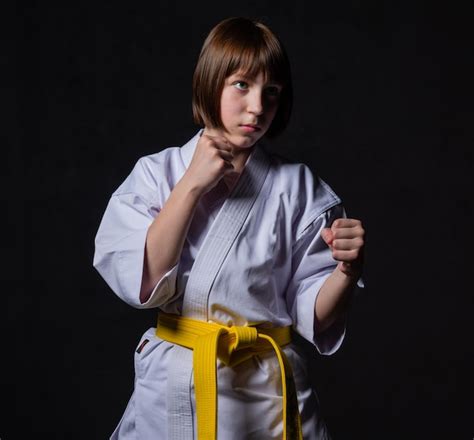 Premium Photo A Karate Girl Trains In A Kimono With Punches And Kicks