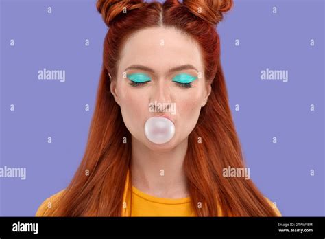 Beautiful Woman With Bright Makeup And Closed Eyes Blowing Bubble Gum