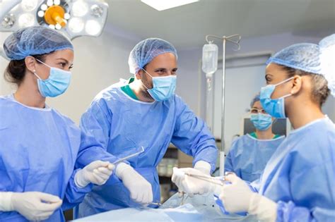 Free Photo Surgeons Men And Women In One Team During An Operation Over The Operating Table