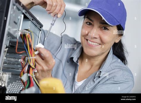 Happy Mature Woman Testing Voltage Of A Pc Stock Photo Alamy