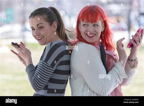 Blind Young Women Using Assistive Technology On Their Cell Phones Stock