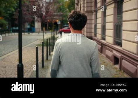 Back View From Behind Unrecognizable Man Unknown Guy Walking Outdoors Going In City Turning