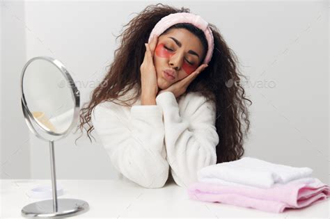 Lovely Tanned Curly Latin Lady With Pink Patch For Eye Reclines On