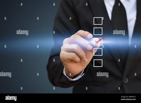 Businessman Writing Red Check Mark In A Checkbox On Blue Background Stock Photo Alamy