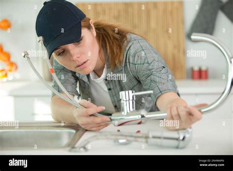 Pretty Woman Dealing With Pipe Leak Stock Photo Alamy