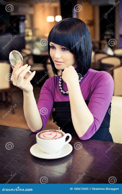 Attractive Woman Sitting In A Cafe With A Cup Of Coffee Stock Image
