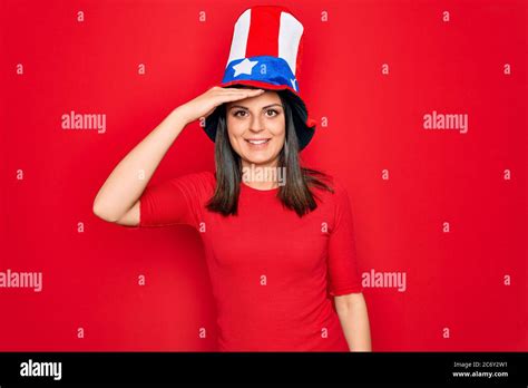Young Beautiful Brunette Woman Wearing United States Hat Celebrating