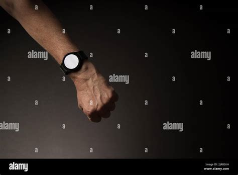 Man S Hand With Smart Watch On Wrist Displaying Blank White Screen Isolated On Dark Background