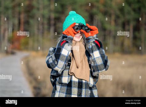 Interested Woman Bird Watcher Smiling Looks Trough Binoculars Walks In Fall Forest Watching