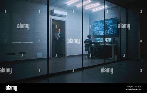 African American Cctv Operator Works On Computer Watching Security Cameras In Office