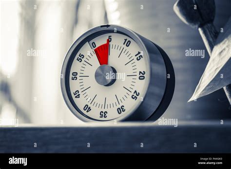 5 Minutes Analog Kitchen Timer With Red Mark Placed Next To A