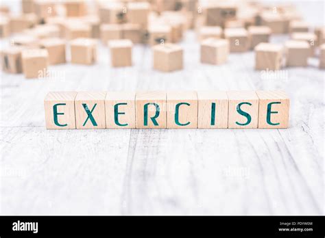 The Word Exercise Formed By Wooden Blocks On A White Table Reminder