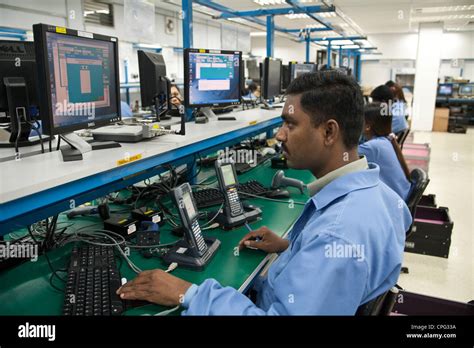 Workers Test Hand Held Inventory Computer Devices On The Assembly Line At The Venture Corp
