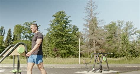 Muscular Man Strength Training At Outdoor Gym Fitness Exercise And