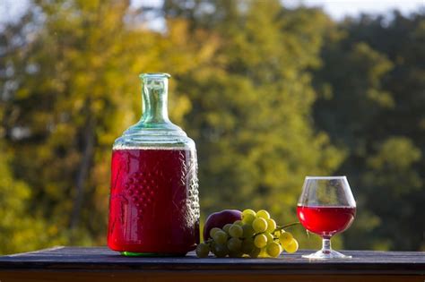 Premium Photo Red Wine In A Glass And Bottle Blurred Background