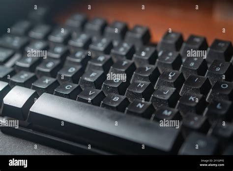 Close Up View Of A Black Computer Keyboard With Various Function Keys And Alphanumeric Keys The