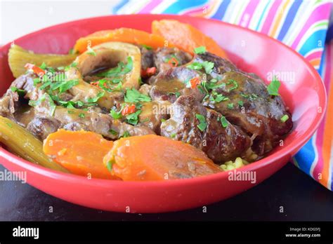 Italian Traditional Veal Dish Osso Buco With Cooked Carrots Potato Celery In A Red Ceramic