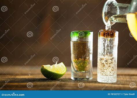 Pouring Tequila Into Shot Glass Selective Focus Blurred Background