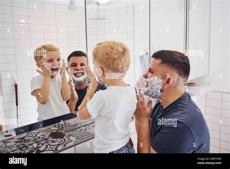 Father With His Son Is In The Bathroom Have Fun By Using Shaving Gel