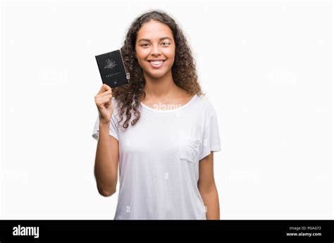 Young Hispanic Woman Holding Passport Of Australia With A Happy Face