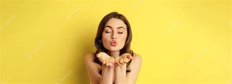Premium Photo Close Up Portrait Of Beautiful Coquettish Woman Sending Air Kiss Blowing Mwah At
