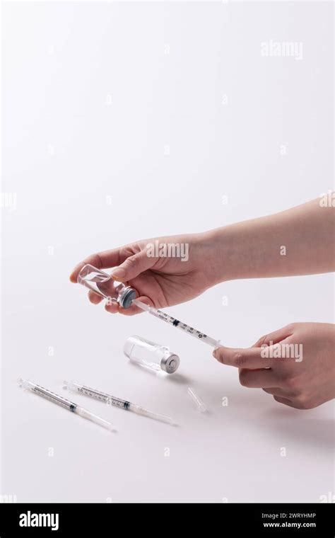 Putting A Syringe In An Injection Bottle Stock Photo Alamy
