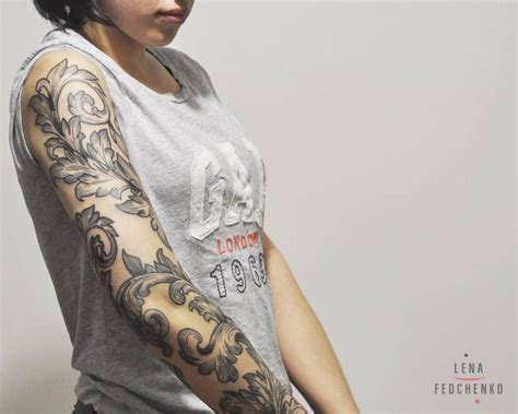 A Woman With A Tattoo On Her Arm