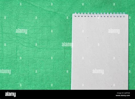 White And Gray Notepad Sheet With Spiral Against The Background Of